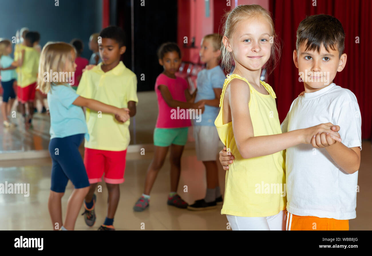Group of nice children dancing salsa dance in modern studio Stock Photo ...