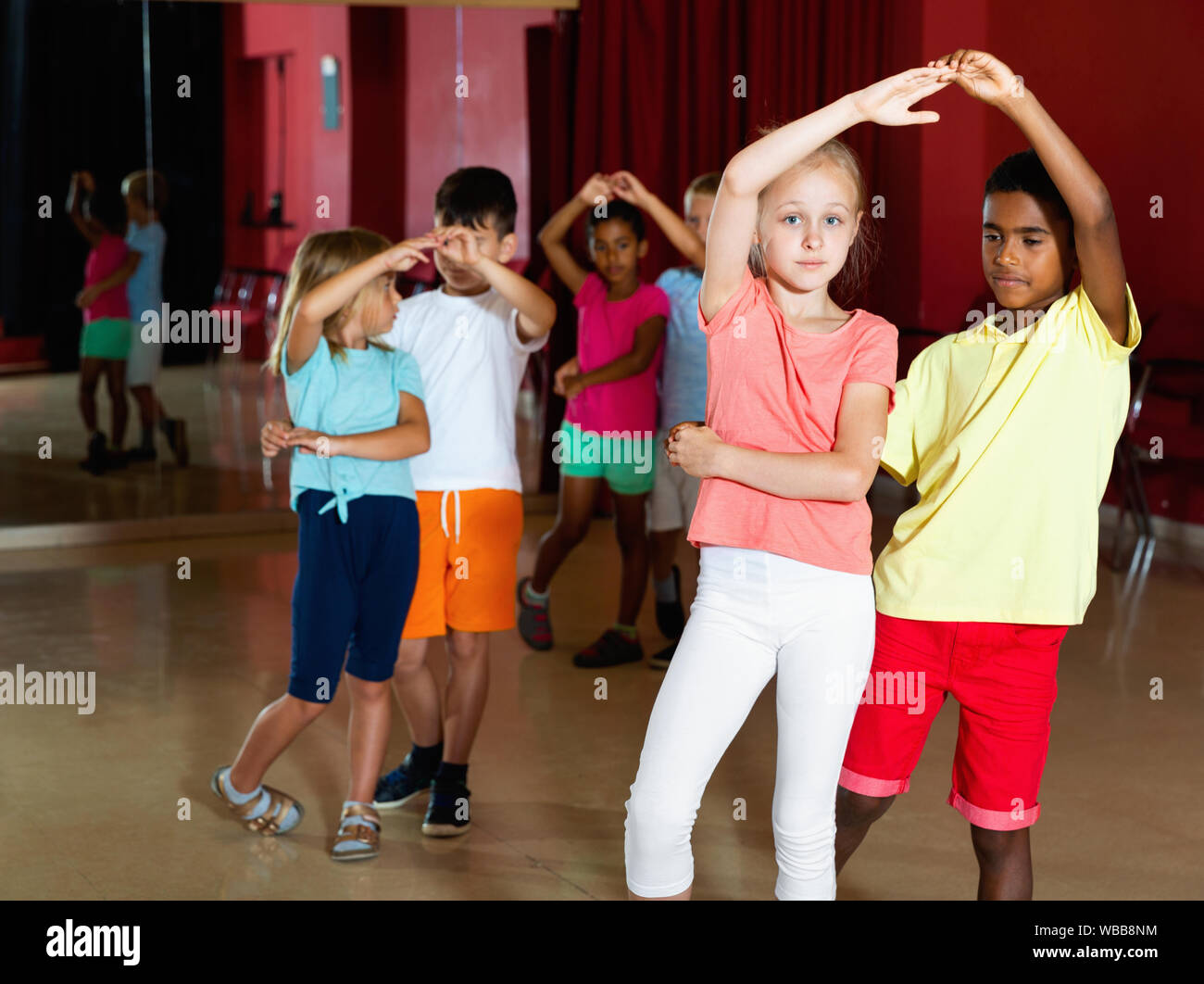 Smiling happy cheerful children primary school trying dancing salsa ...