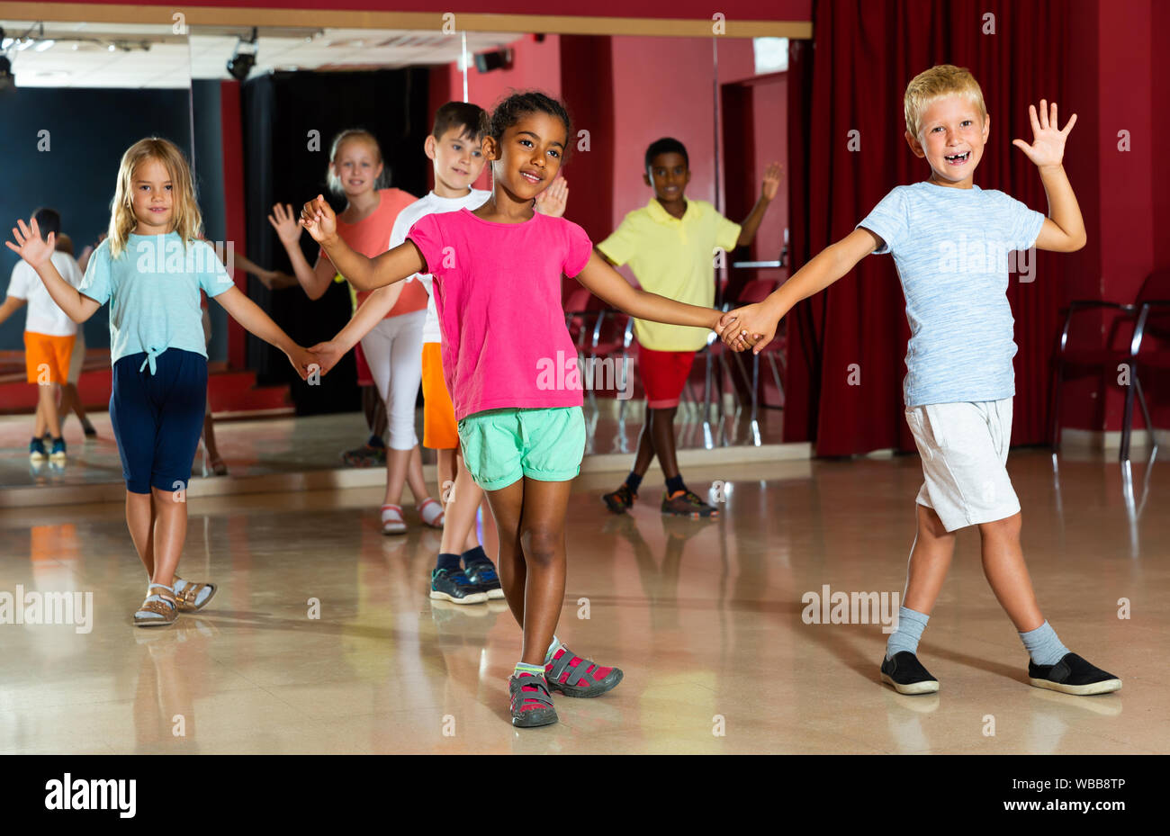 Joyful children trying dancing partner dance in modern studio Stock ...