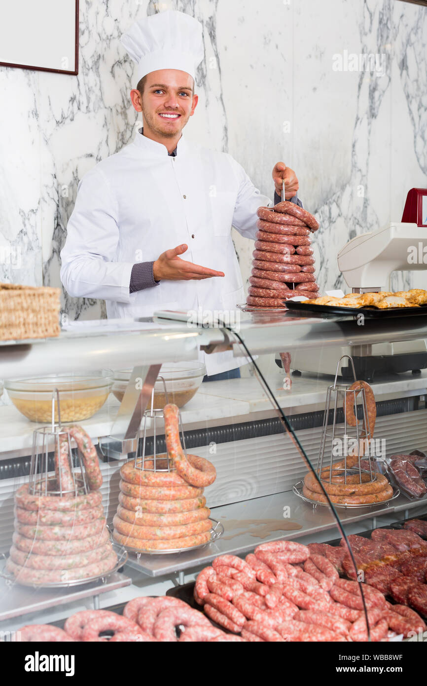 Happy ordinary man seller working at meat market Stock Photo - Alamy