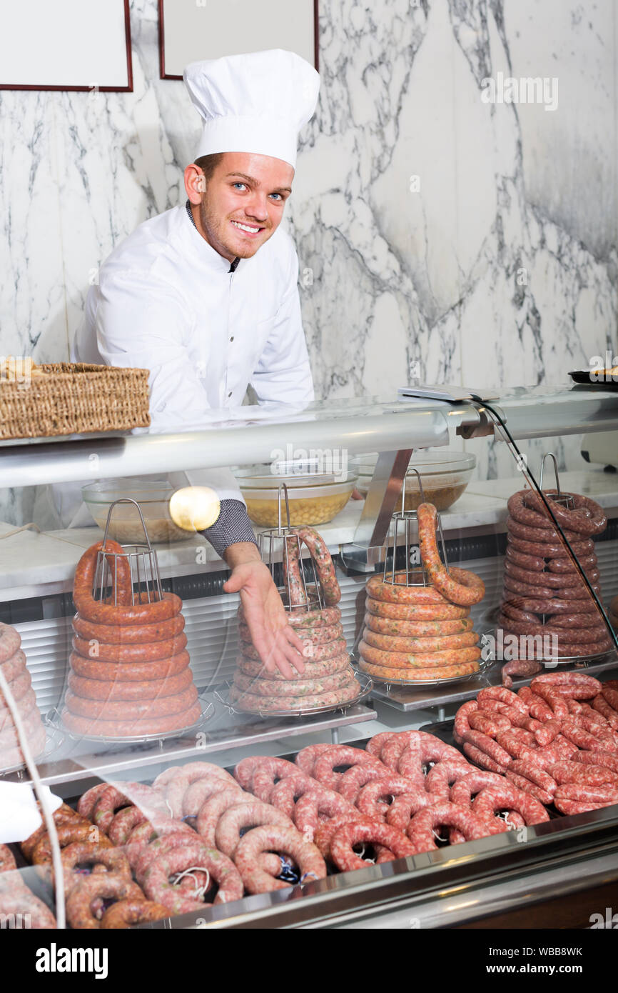 Laughing ordinary man seller working at meat market Stock Photo - Alamy