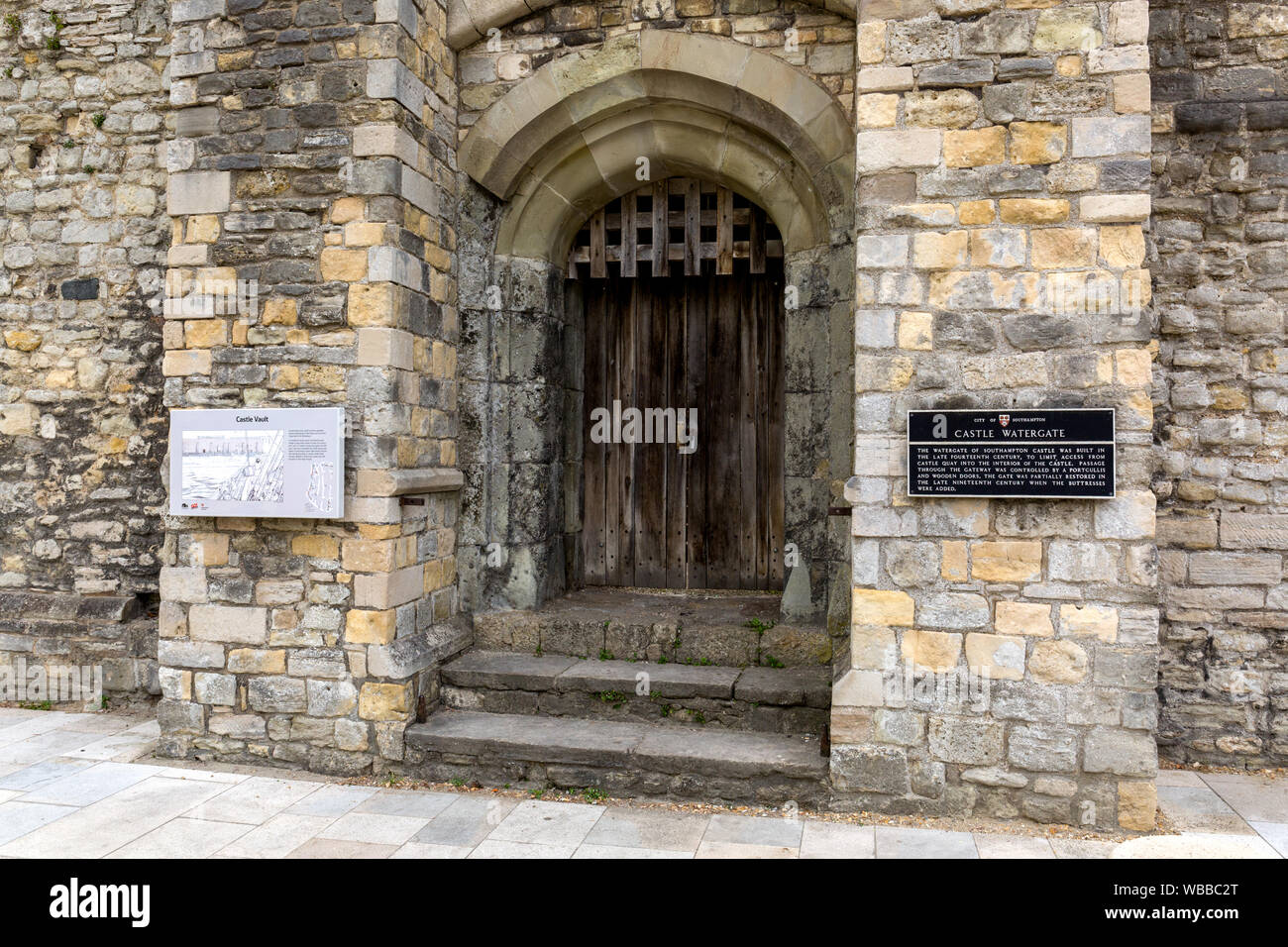 Castle watergate. 14th century gateway. Tourist information plaque ...