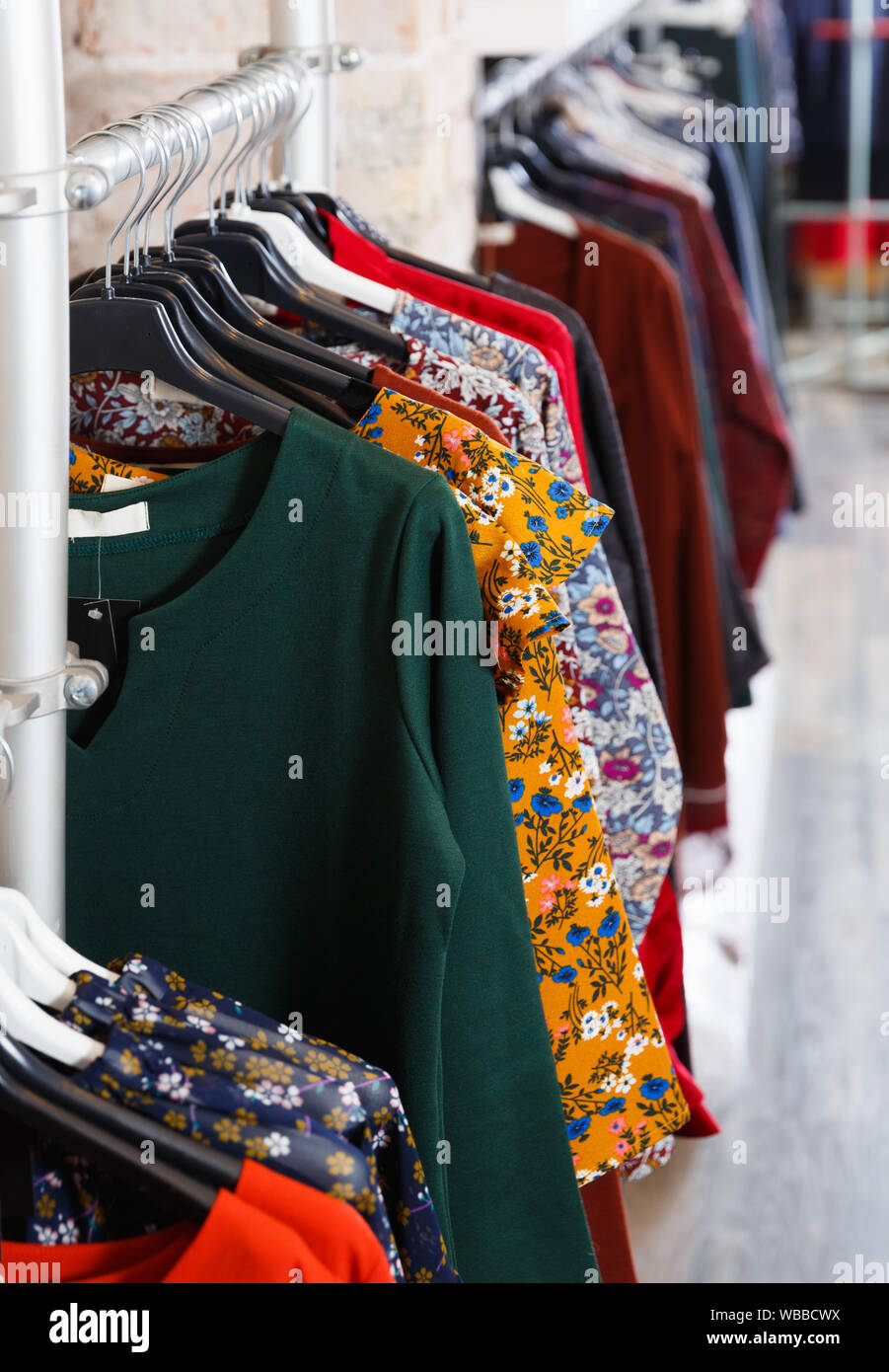 Different assortment of colorful clothing in the modern boutique Stock ...