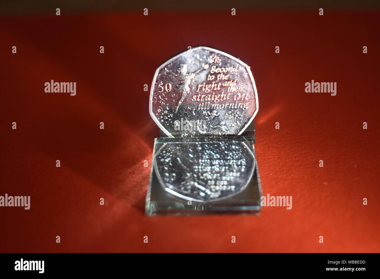 Peter Pan 50p with mirror reflection and colourful background Stock ...