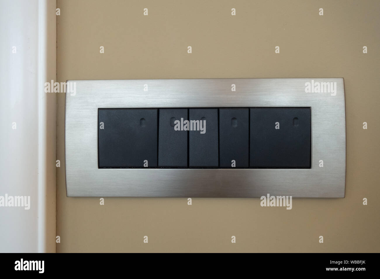 Five-way switch with black buttons and an aluminum frame on a green ...