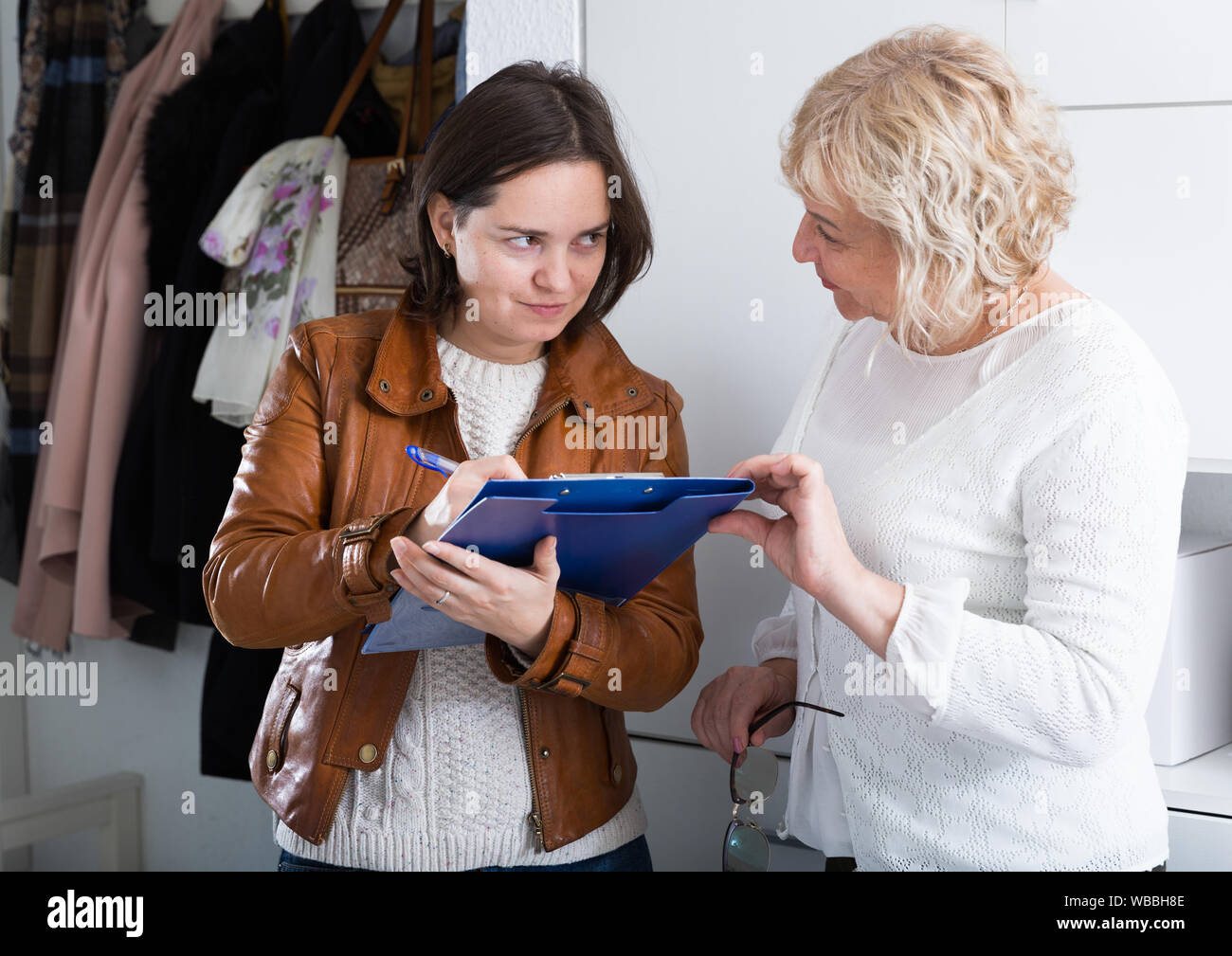 Interviewer interviews a mature woman at home, a social or commercial ...