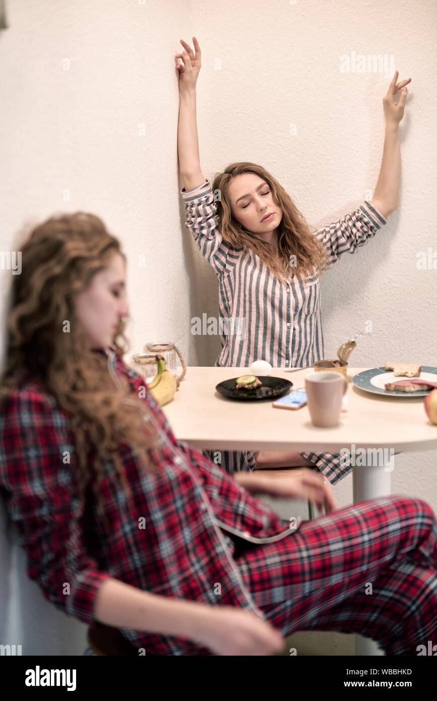 tired women at breakfast table, morning Stock Photo - Alamy