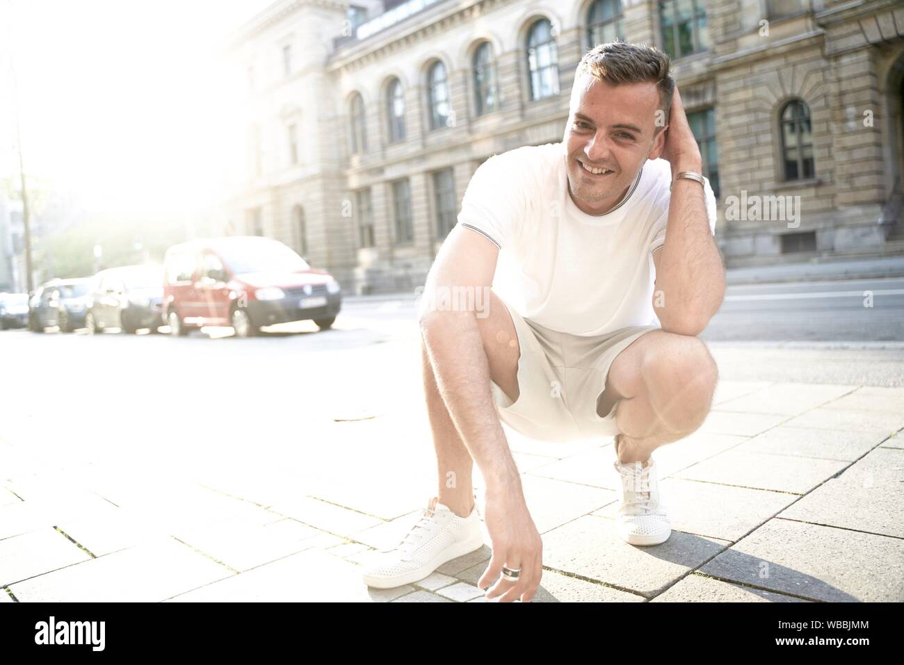 Crouching male figure hi-res stock photography and images - Alamy
