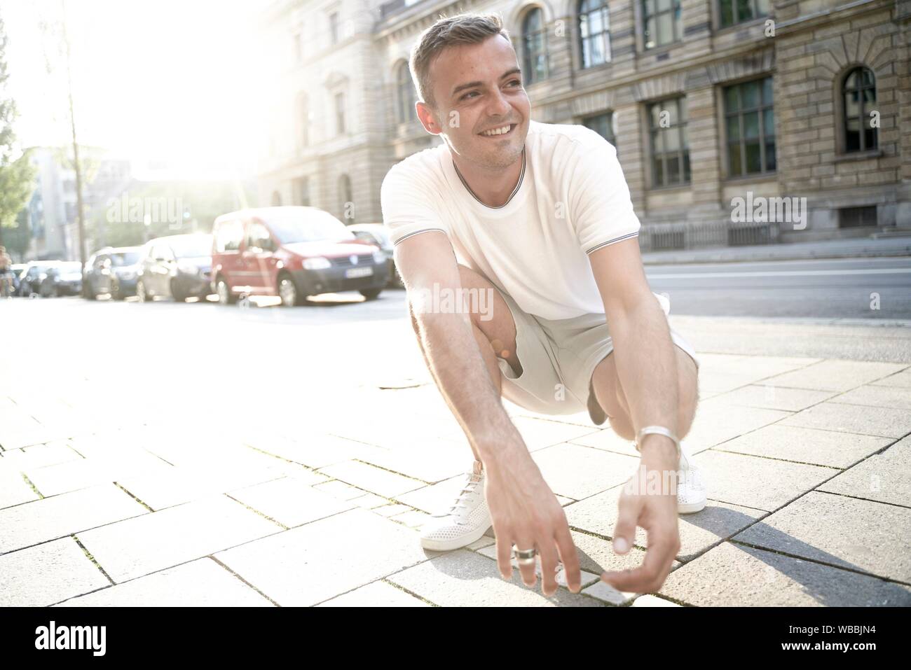 Crouching male figure hi-res stock photography and images - Alamy