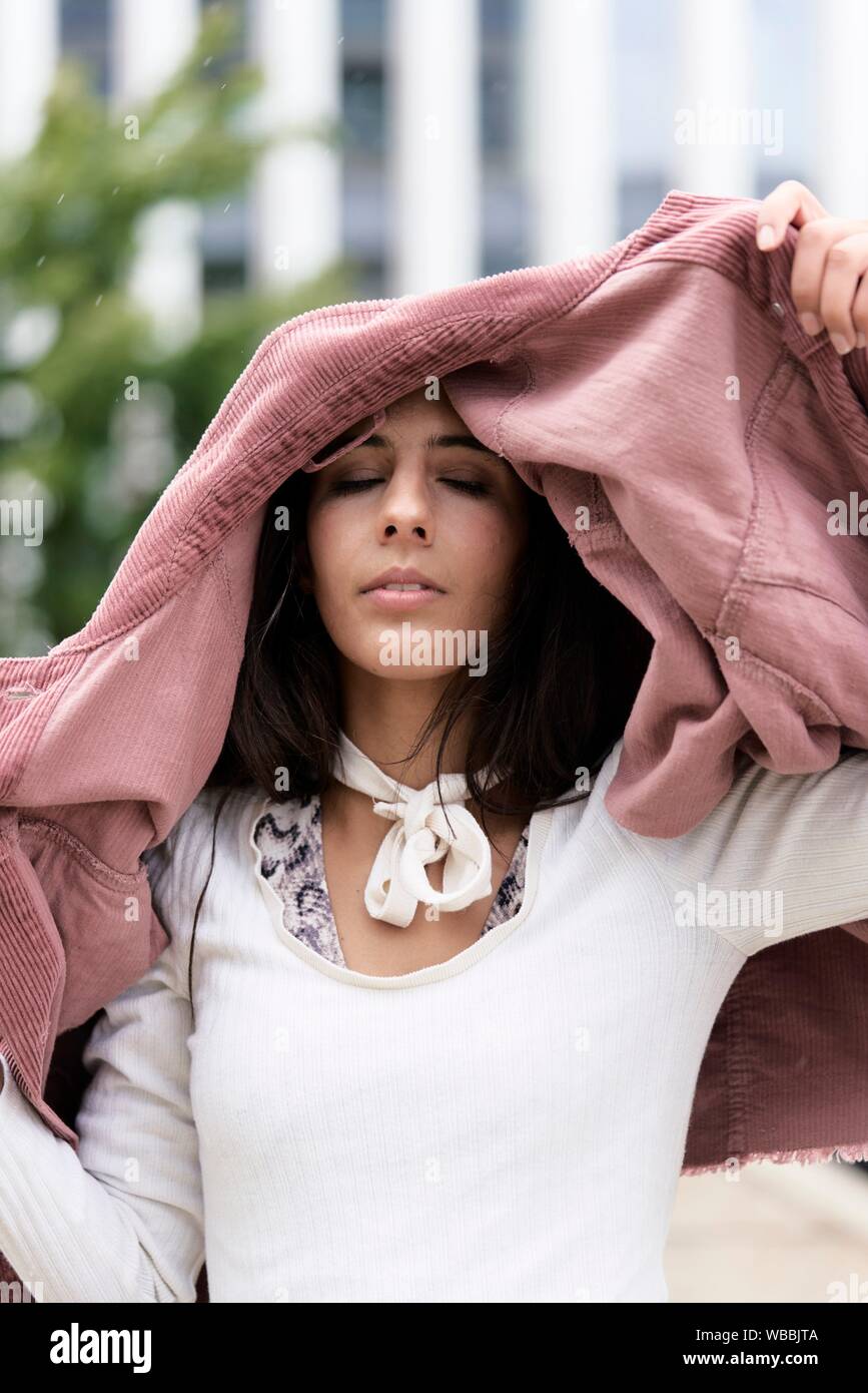 Woman Taking Off Jacket High Resolution Stock Photography and Images ...
