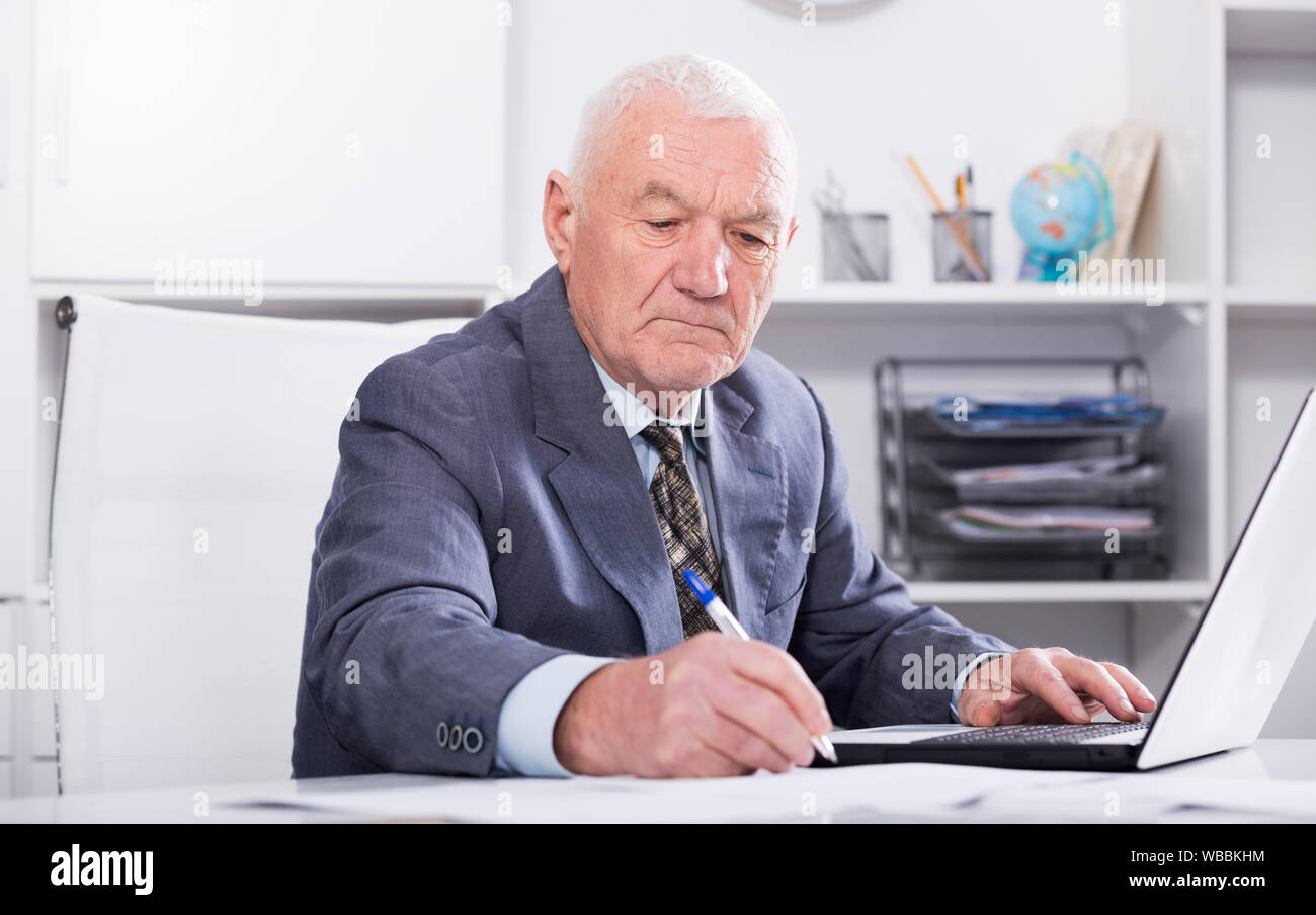 Smiling man worker working effectively on project in office Stock Photo ...