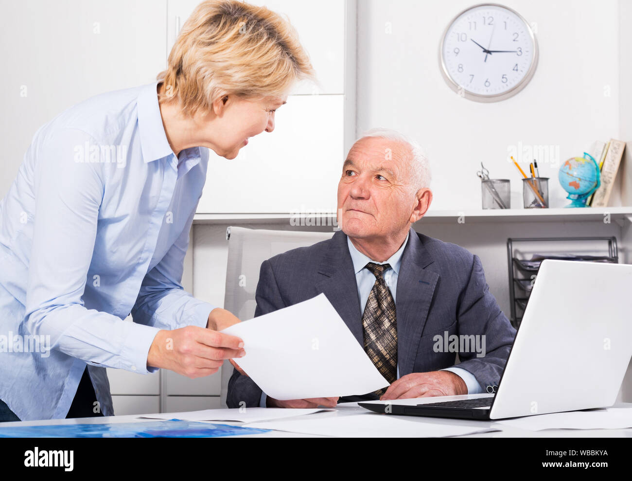 Aged manager and secretary working effectively together in office Stock ...