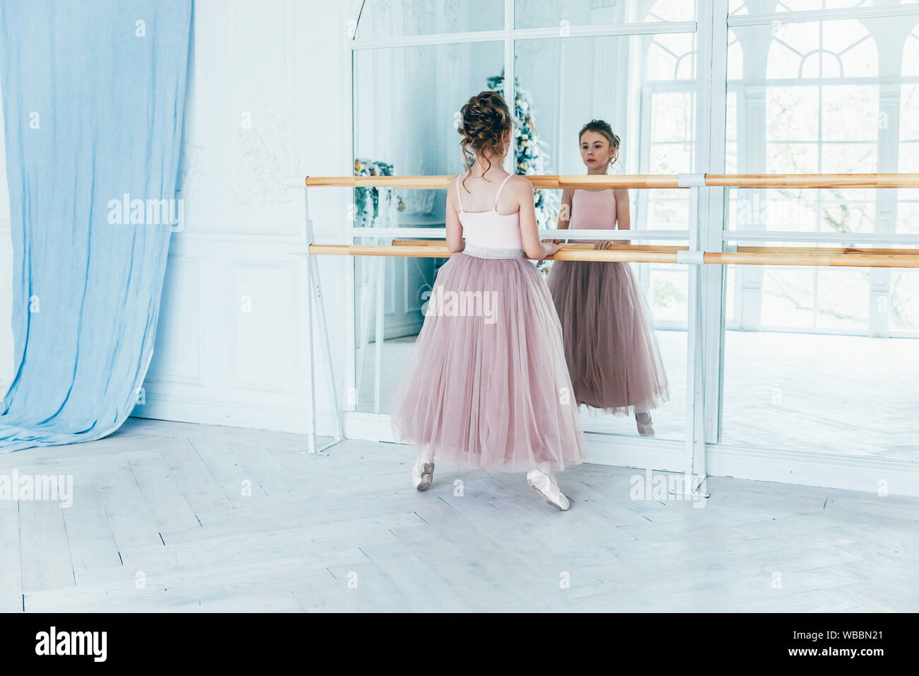 Young classical ballet dancer girl in dance class. Beautiful graceful ...
