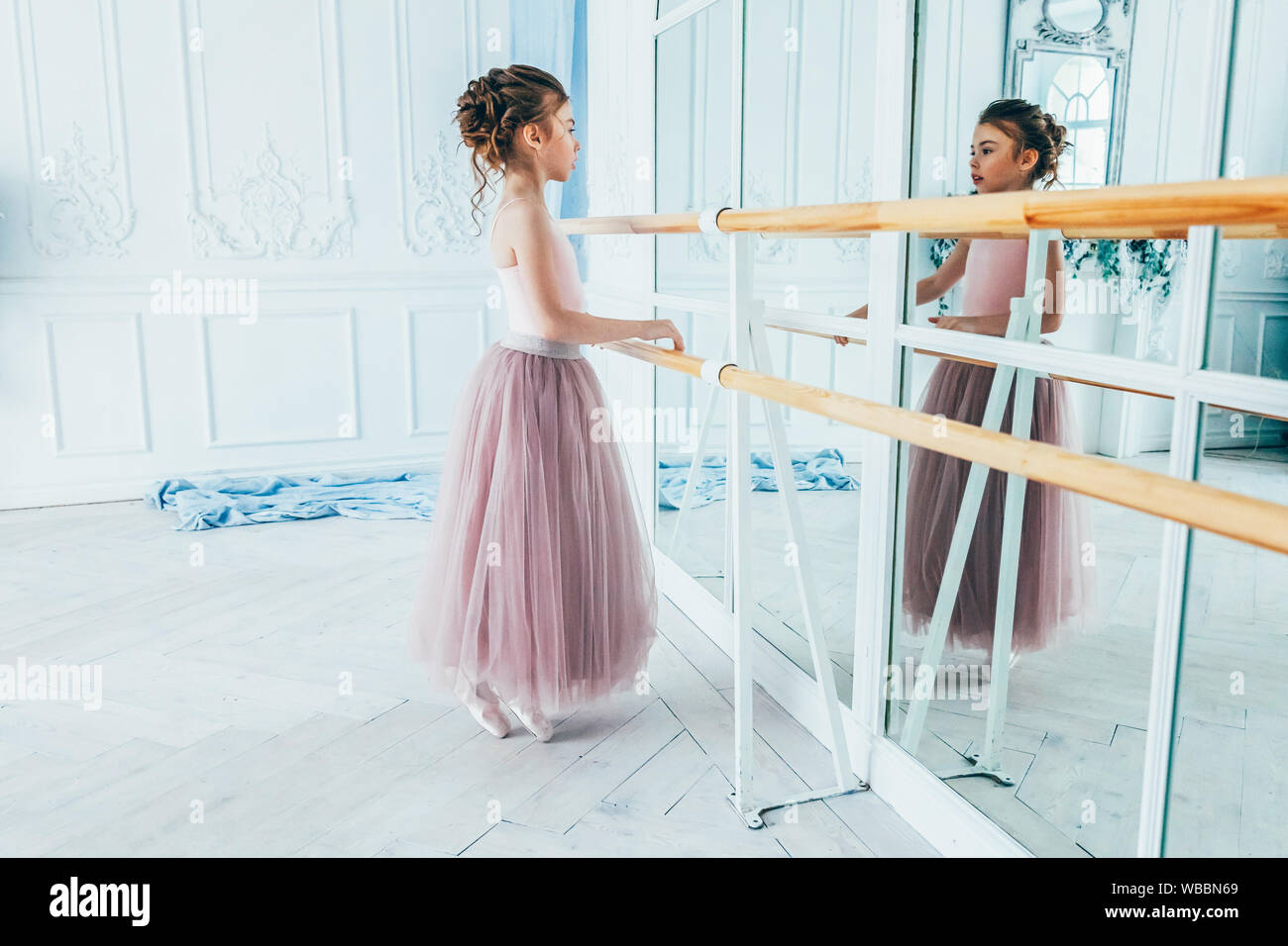 Young classical ballet dancer girl in dance class. Beautiful graceful ...