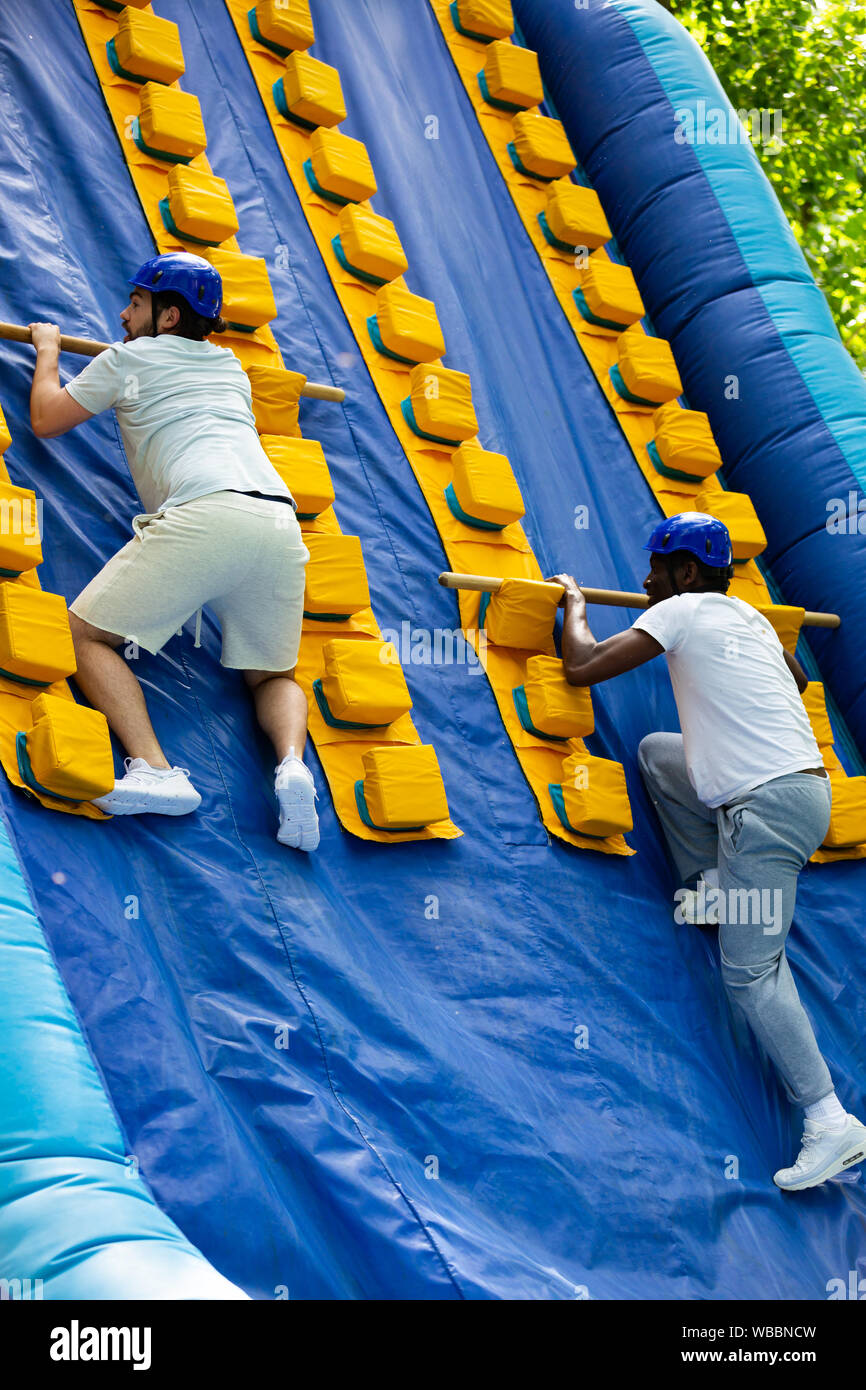 Inflatable slide Great race - climbing with a stick on an inflatable ...