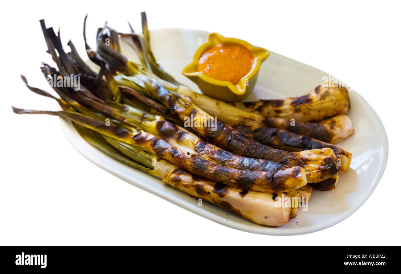Grilled calcots with romesco sauce. National Catalan winter dish served ...