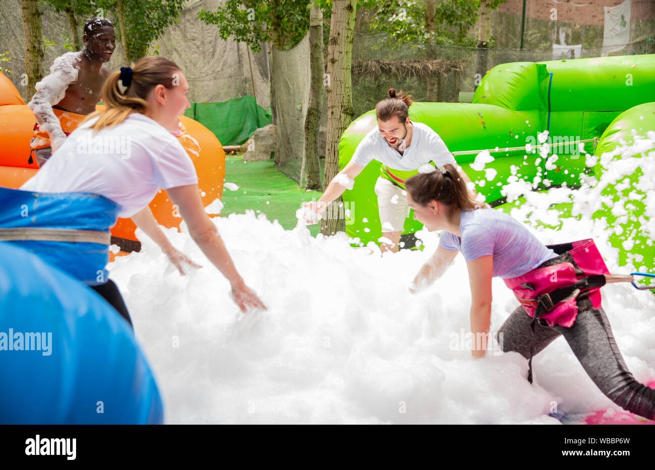 Friendly multiracial team having funny competition in collect of balls ...