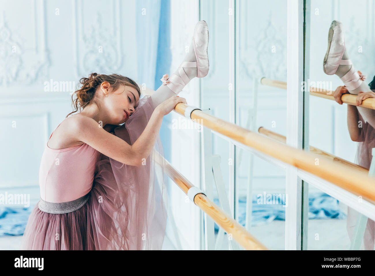 Young classical ballet dancer girl in dance class. Beautiful graceful ...