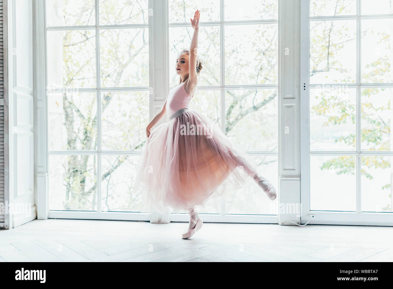 Young classical ballet dancer girl in dance class. Beautiful graceful ...