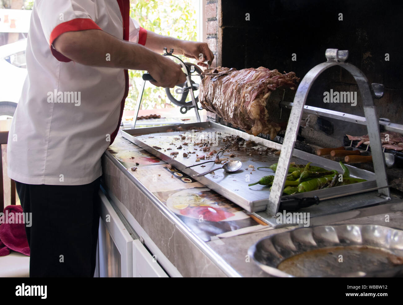 Chef prepares a traditional Turkish cag kebab at an open restaurant in ...