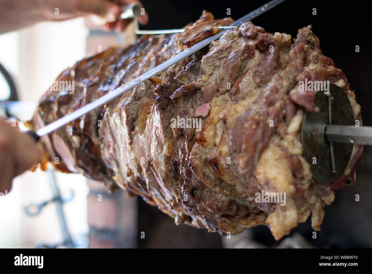 Chef prepares a traditional Turkish cag kebab at an open restaurant in ...