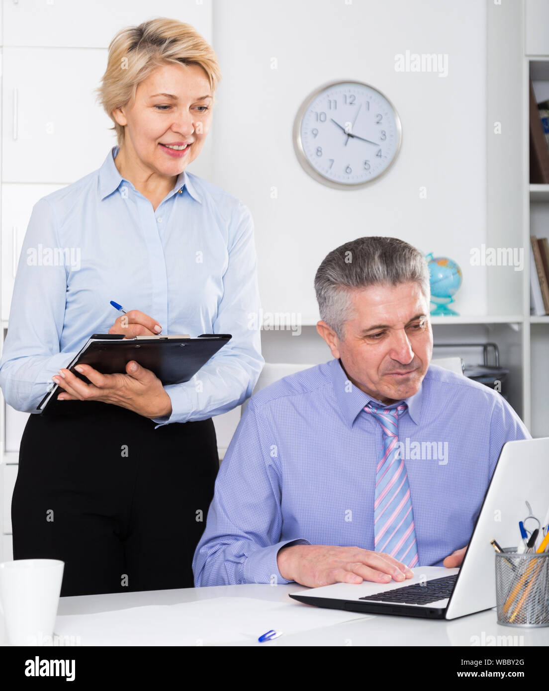 Director's assistant makes daily routine and writes down instructions ...