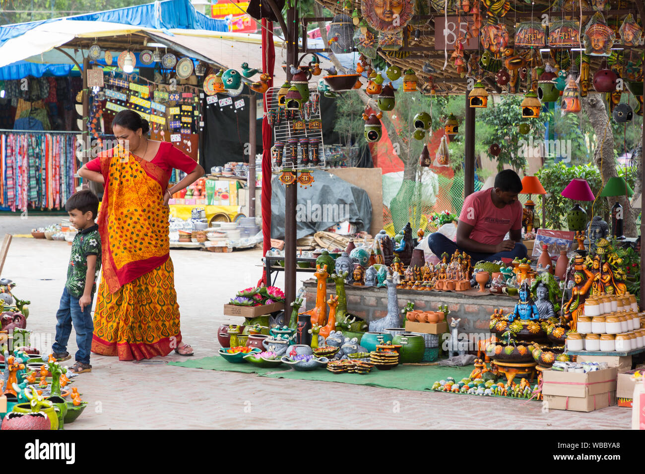 New Delhi, India - August 5, 2018: Woman and son shopping at Dilli Haat ...