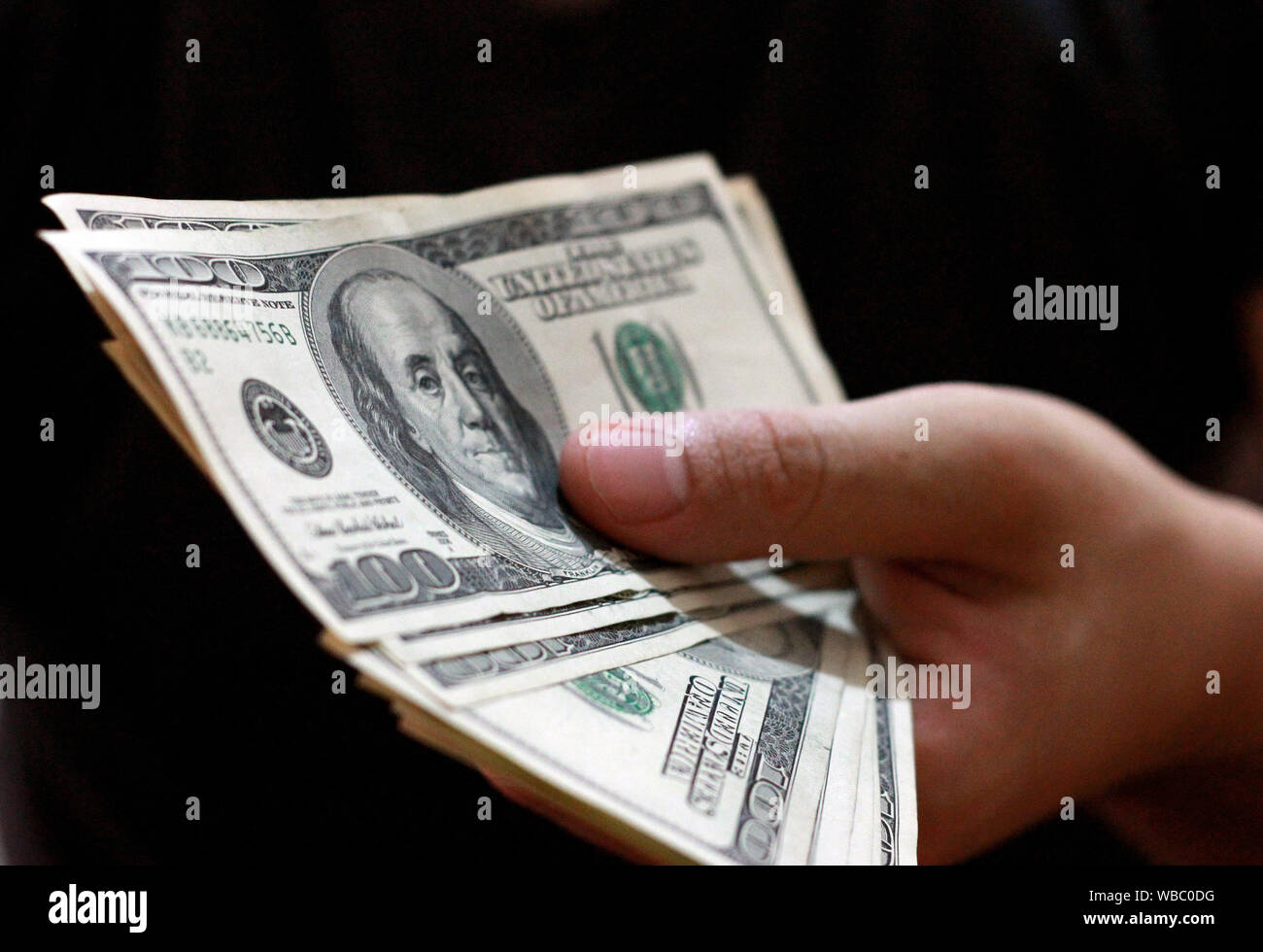 Cash of hundred dollar bills. A pile of one hundred US banknotes .100 ...