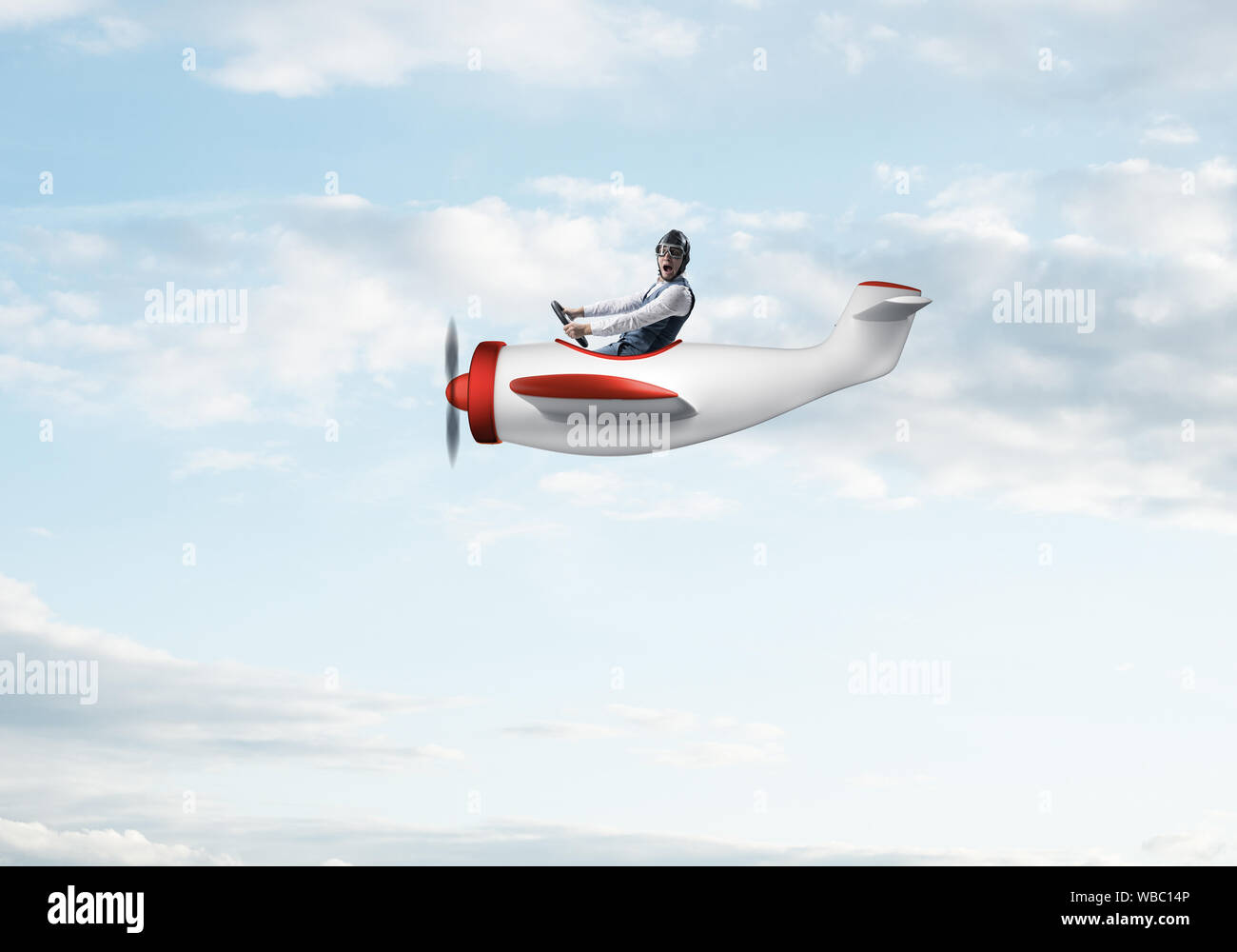 Happy pilot driving small propeller plane on background of blue sky ...