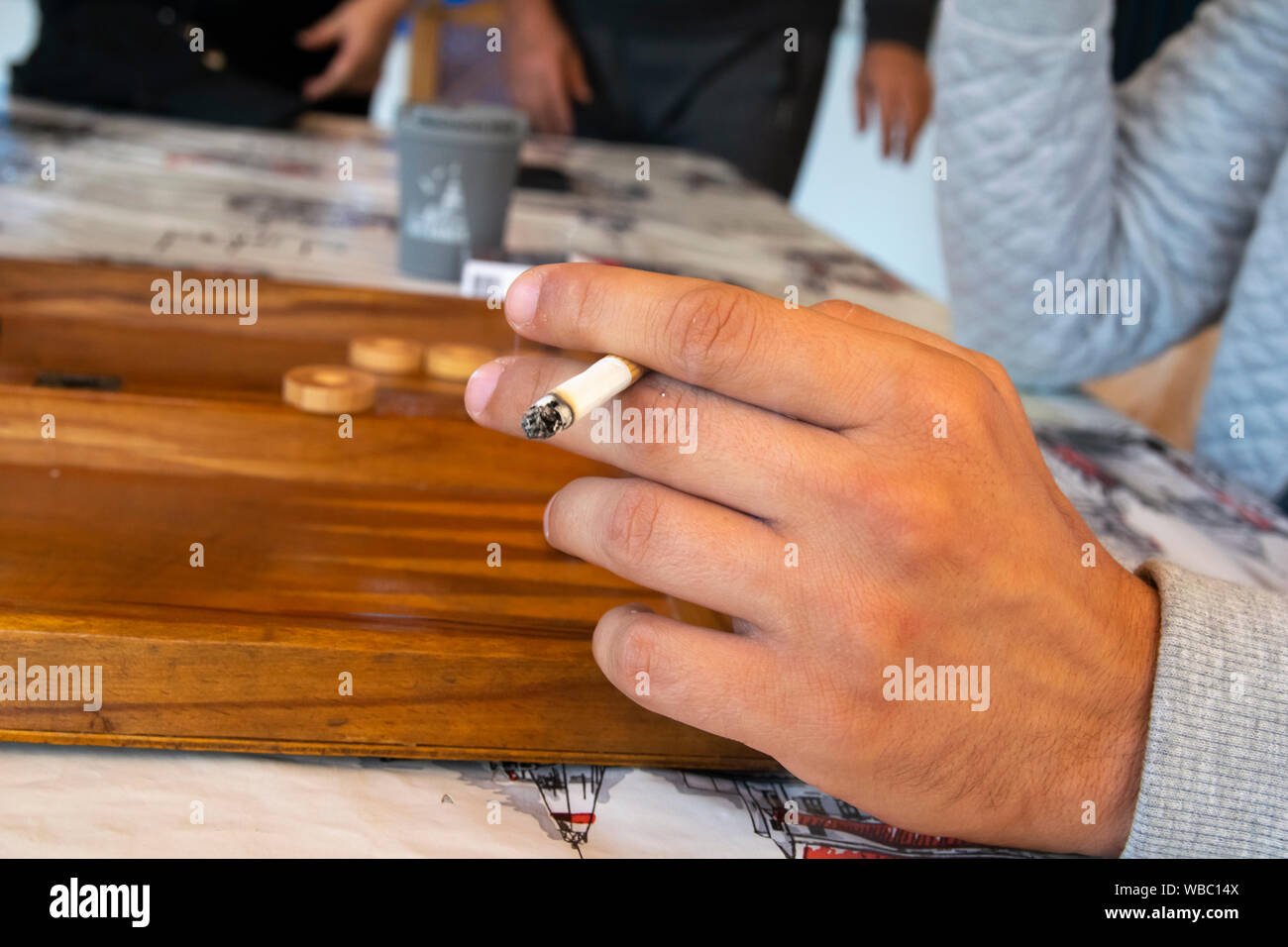Image of cigarette in man hand with smoke Stock Photo - Alamy