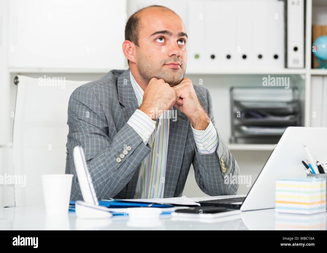Sad businessman thinking about work in the modern office Stock Photo ...