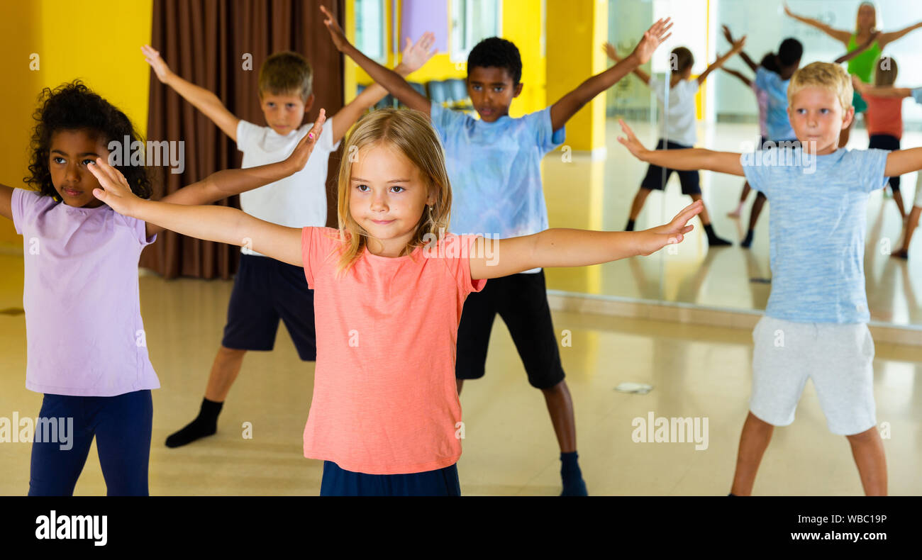 Portrait of smiling children practicing sport dance in modern dance ...