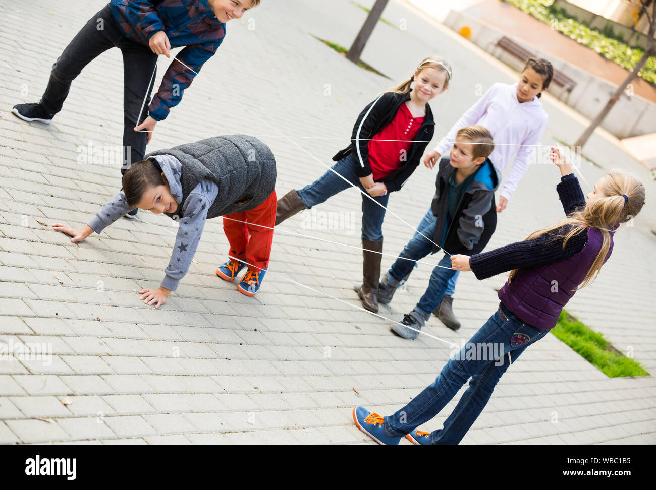 Сhild carefully go through the tangled rope Stock Photo - Alamy