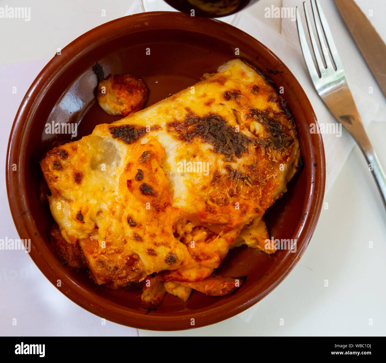 Italian meat lasagna in a clay plate Stock Photo - Alamy