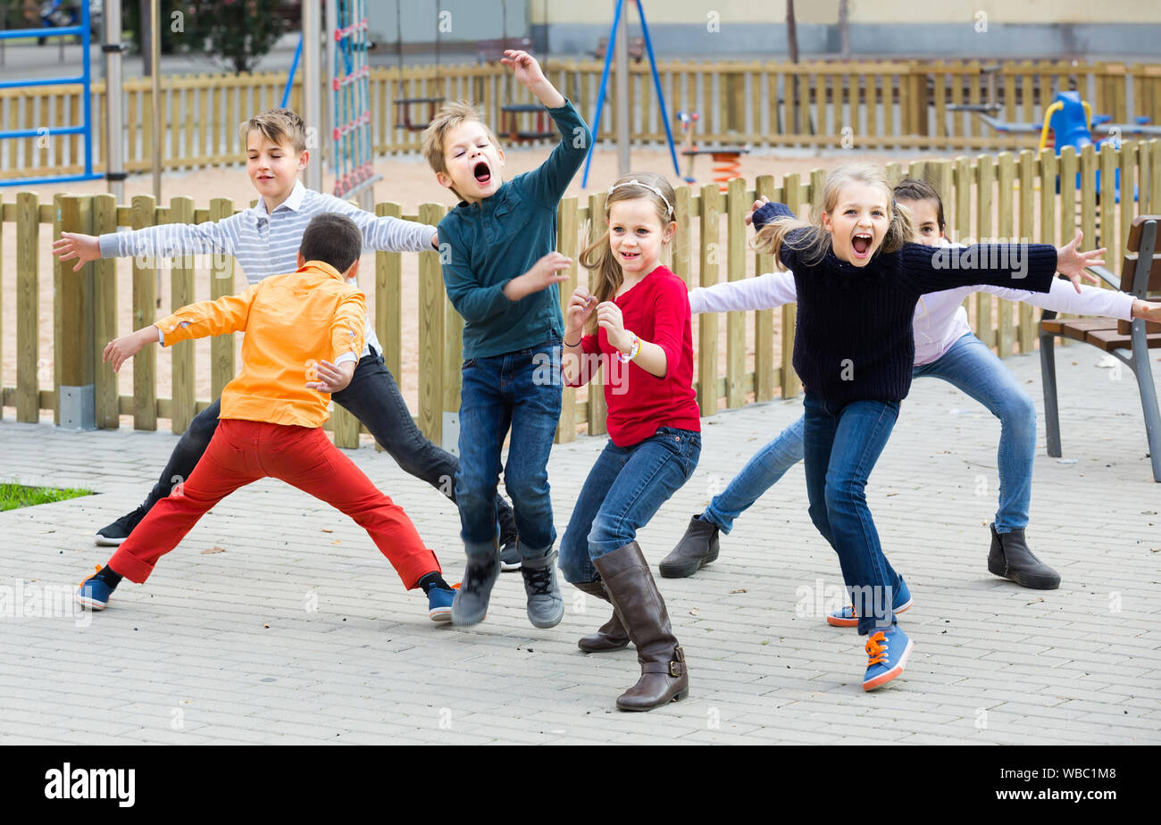 happy european children showing different figures during game in ...