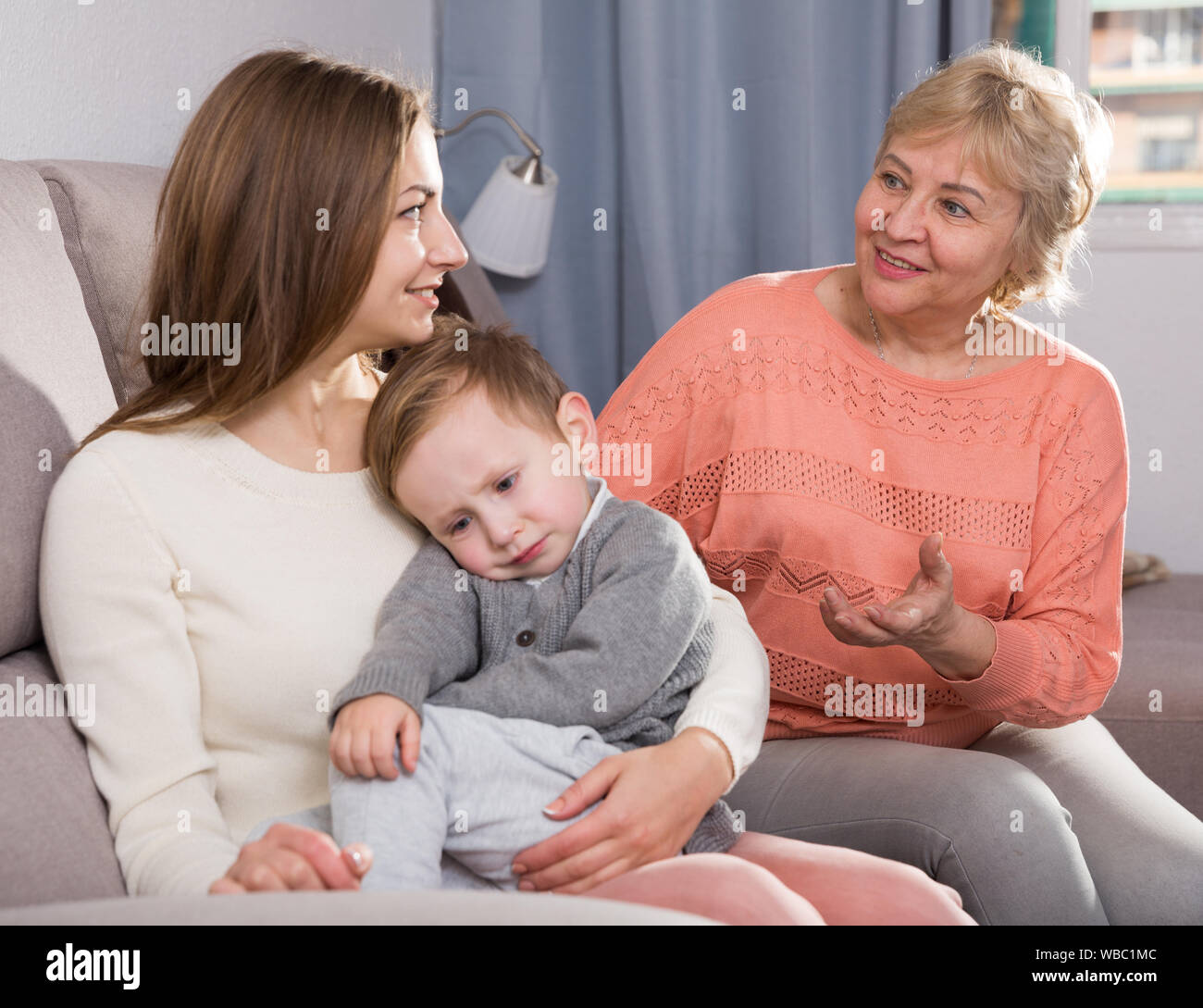 Two adult female are talking about upbringing kid at home Stock Photo ...