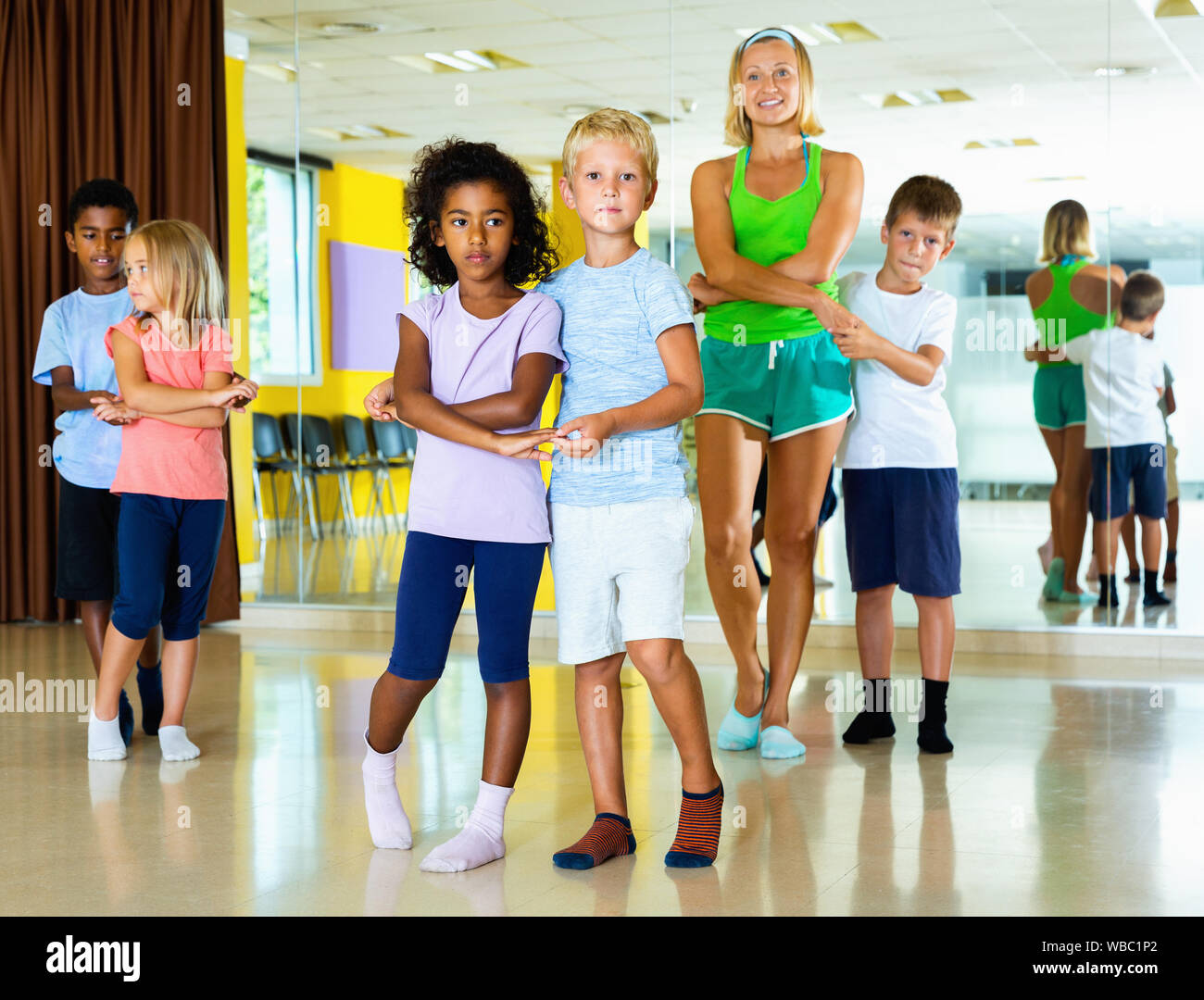 Group of happy cheerful smiling children practicing vigorous jive ...