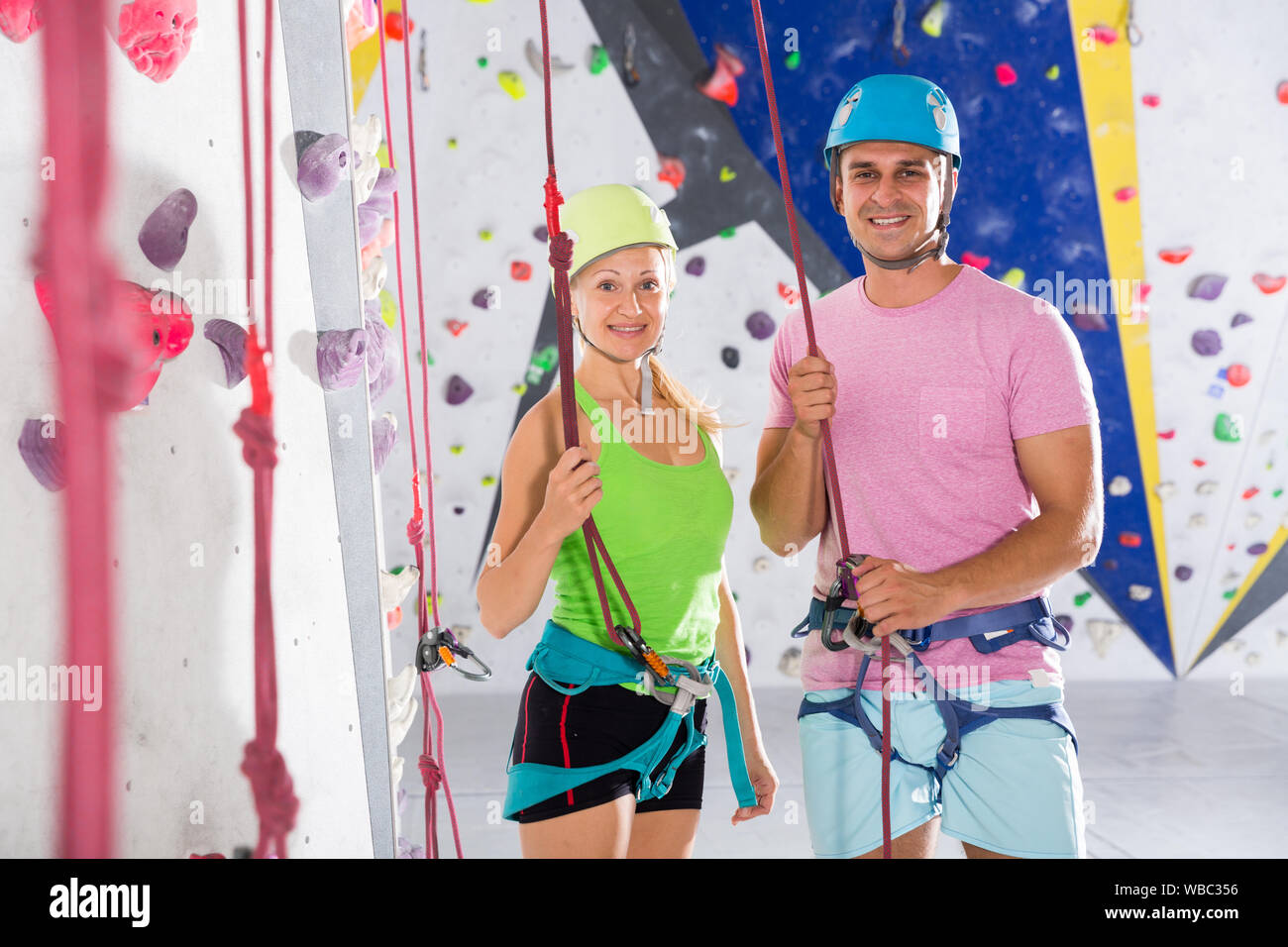 Portrait of two smiling confident athletes in mountaineering outfit ...