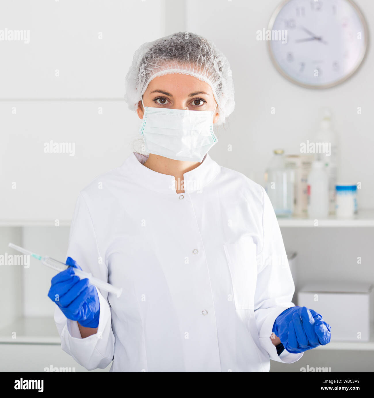 Female nurse holding syringe for injection in hospital Stock Photo - Alamy