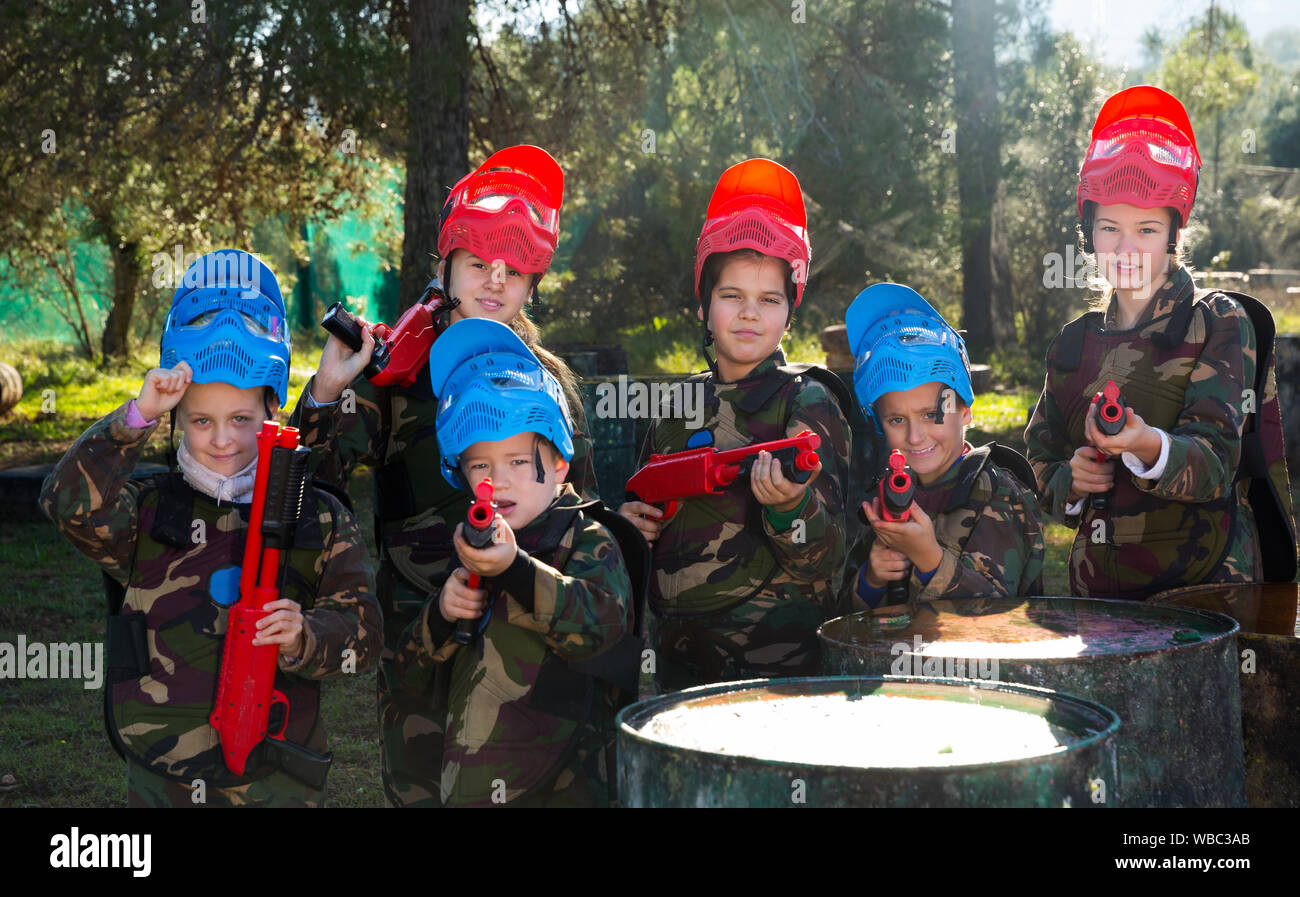 Portrait of group cheerful of boys and girls paintball players with ...
