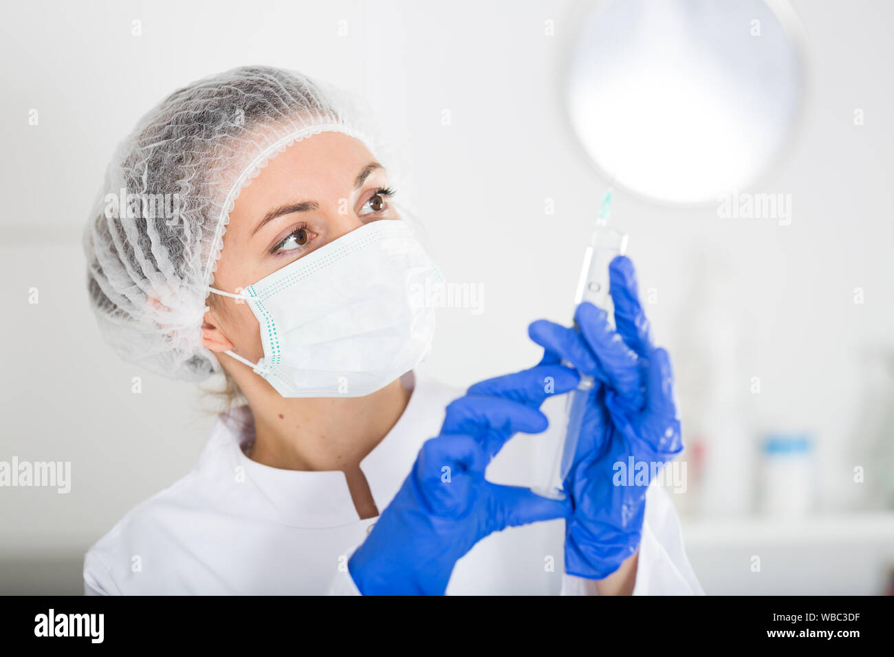 Female nurse holding syringe for injection in hospital Stock Photo - Alamy