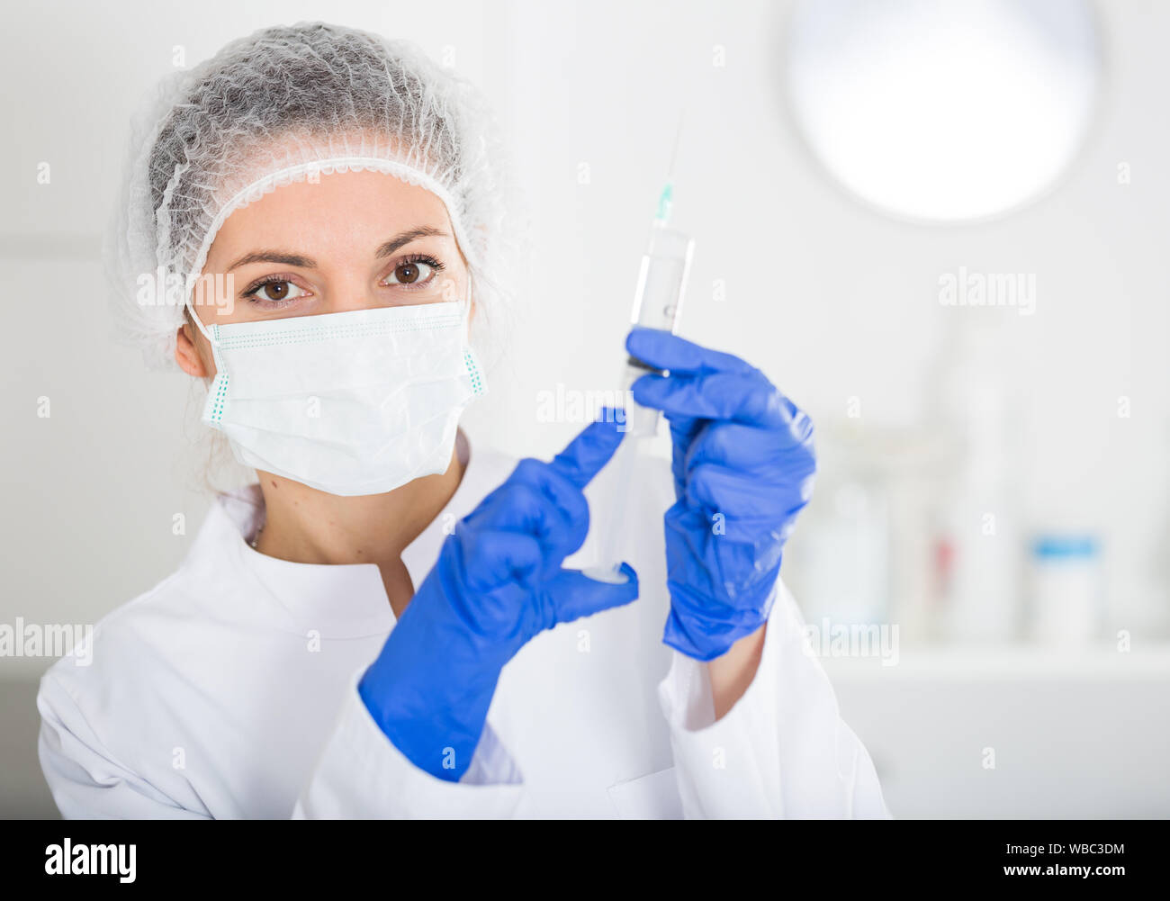 Professional nurse woman making injection in hospital Stock Photo - Alamy