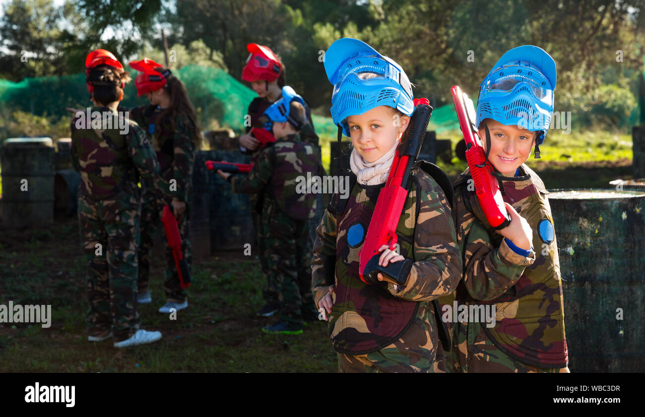 Two friends, boy and girl in camouflage posing with marker guns on ...