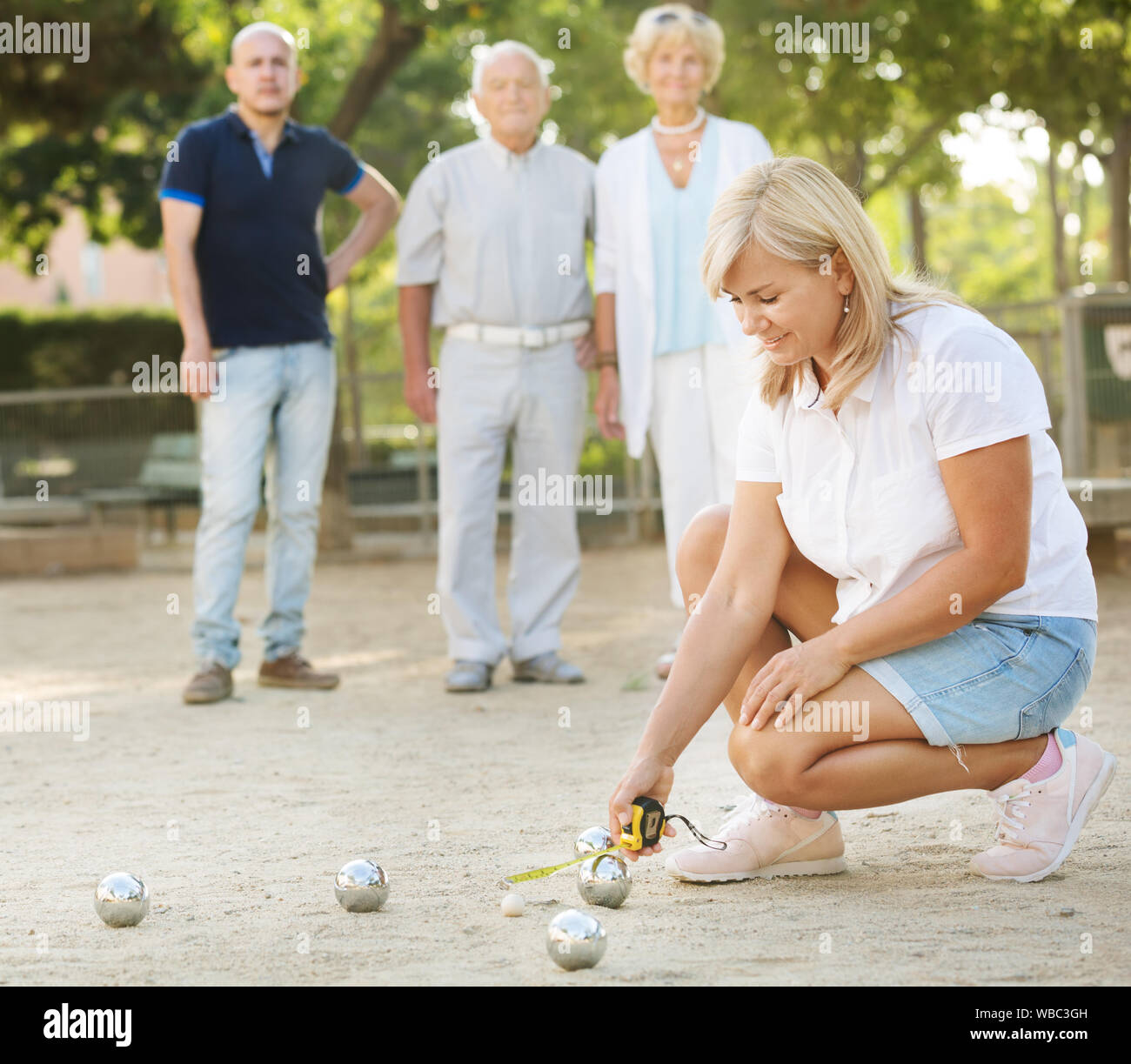 Happy family of two generations playing bocce at garden Stock Photo - Alamy
