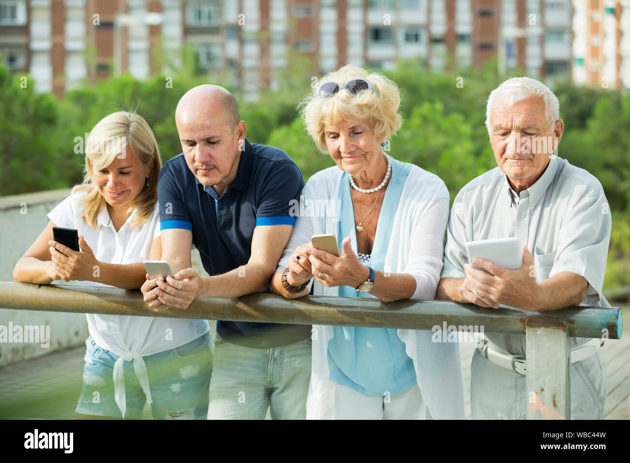 elderly people chatting in phones in the outdoor Stock Photo - Alamy