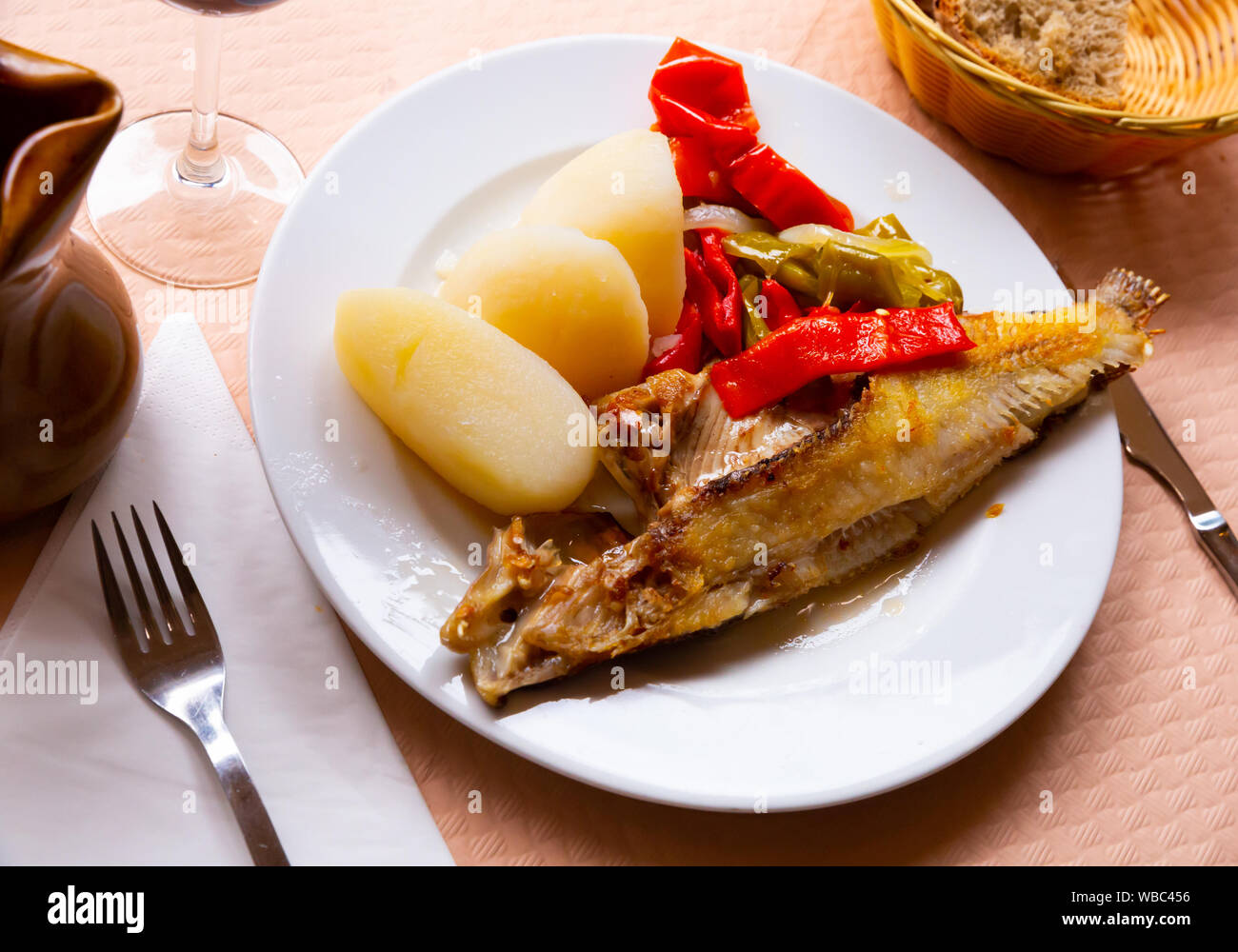 Dish of spanish cuisine – roasted maragota fish (ballan wrasse) with ...