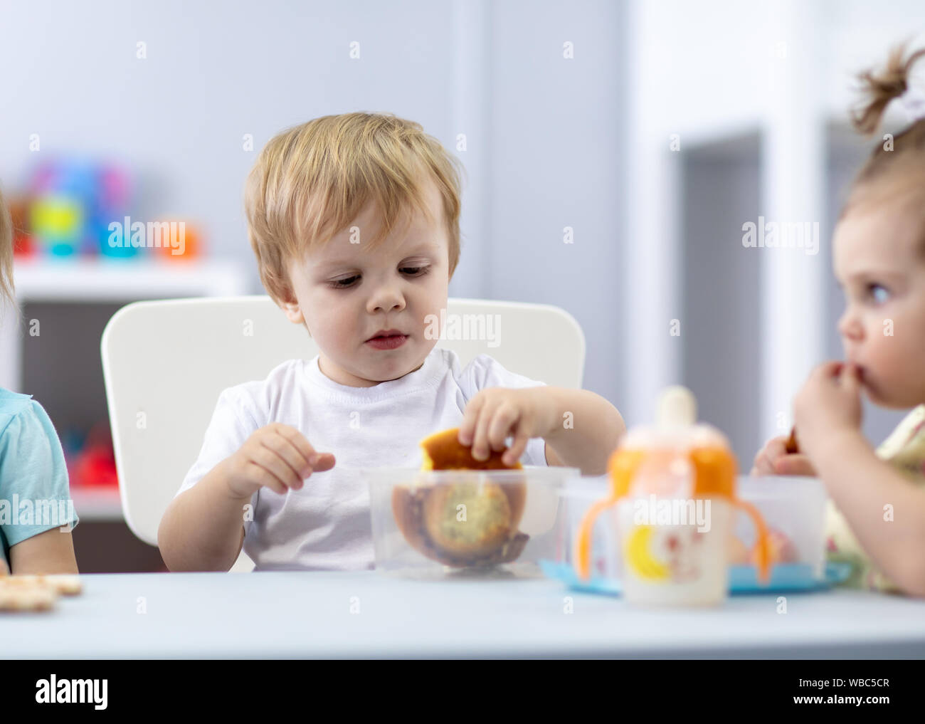 Babies have pause to eat in kindergarten or daycare Stock Photo - Alamy