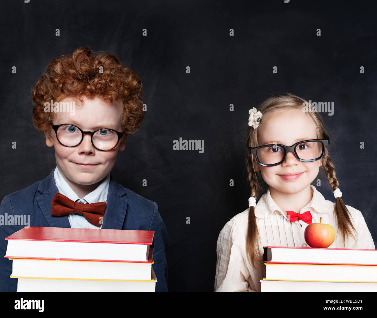 Happy children smart girl and boy students in classroom on chalkboard ...