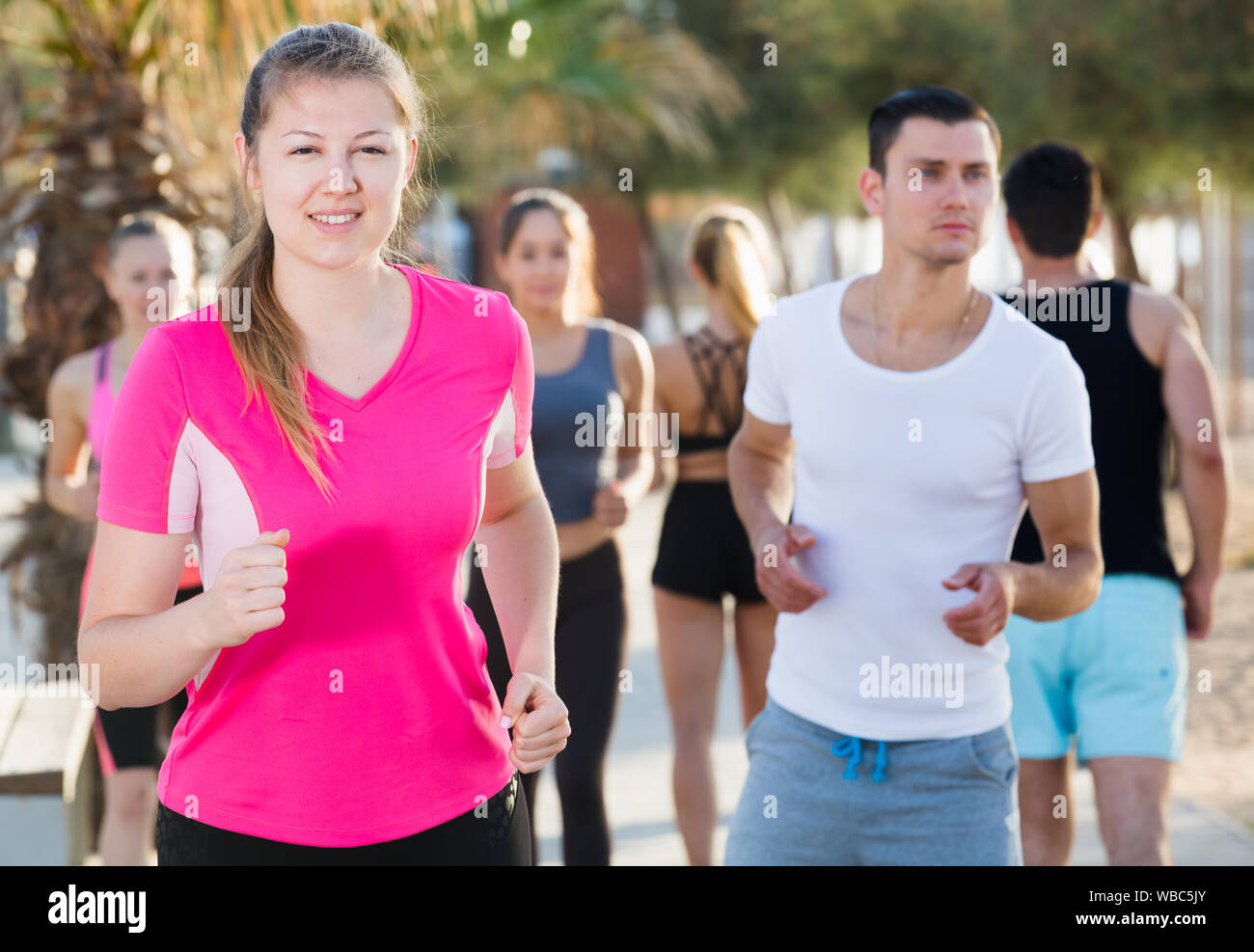 Active smiling people during running training in daytime Stock Photo ...