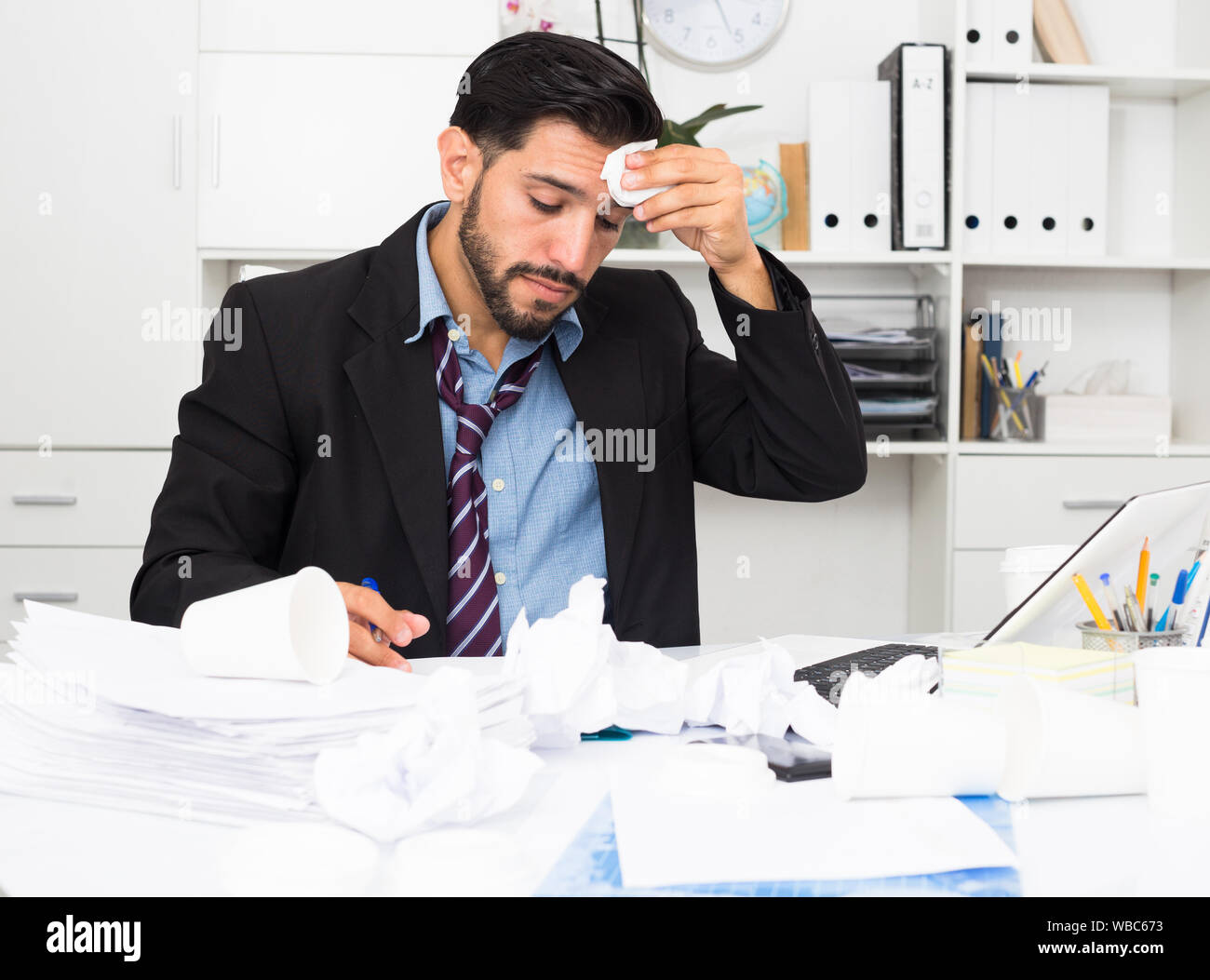 Adult businessman is sad because he is having issues at work place in ...